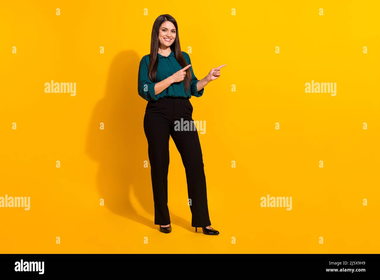 Full body photo of young pretty woman indicate fingers empty space ...