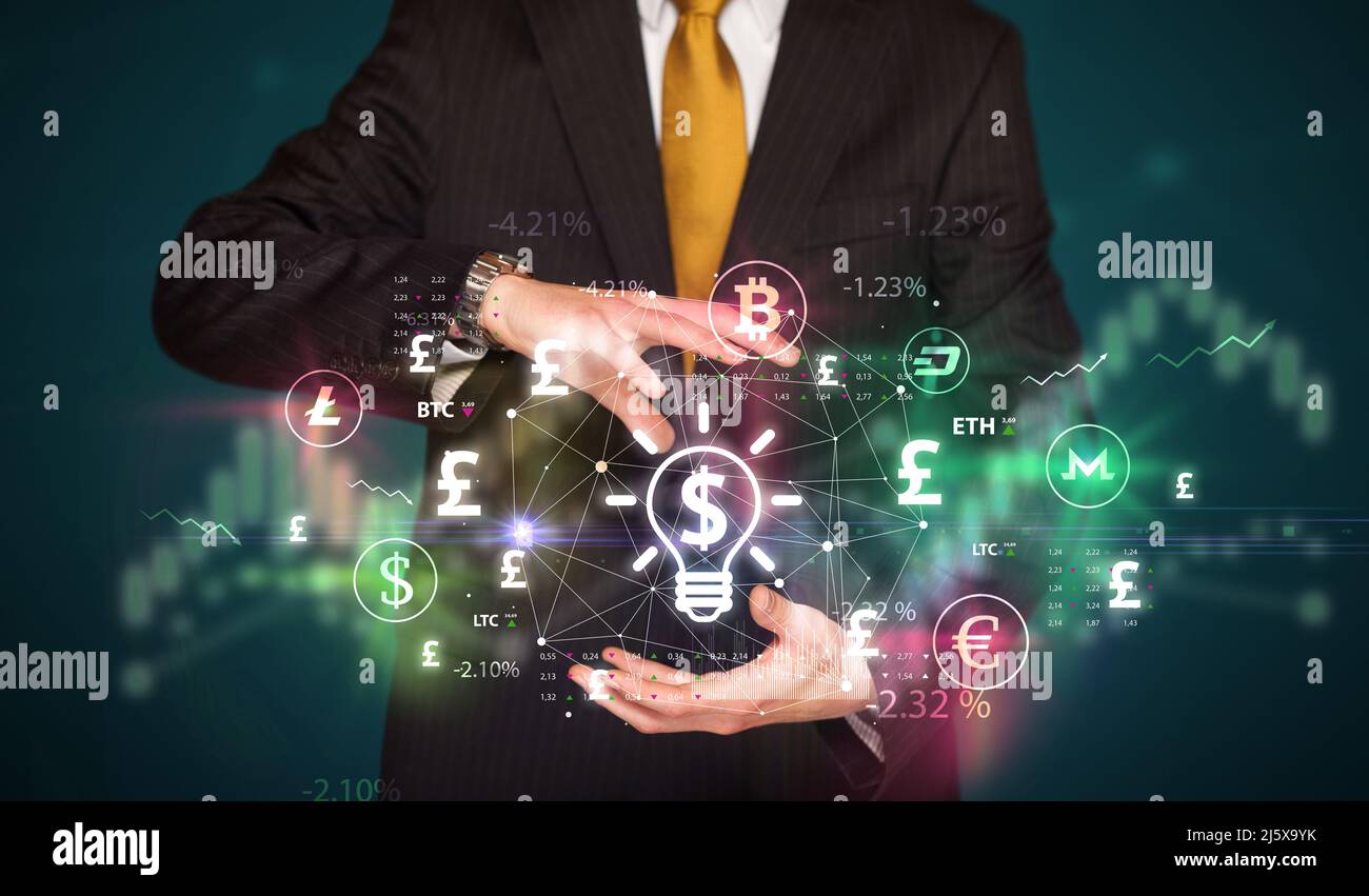 Businessman holding currency symbols concept Stock Photo - Alamy