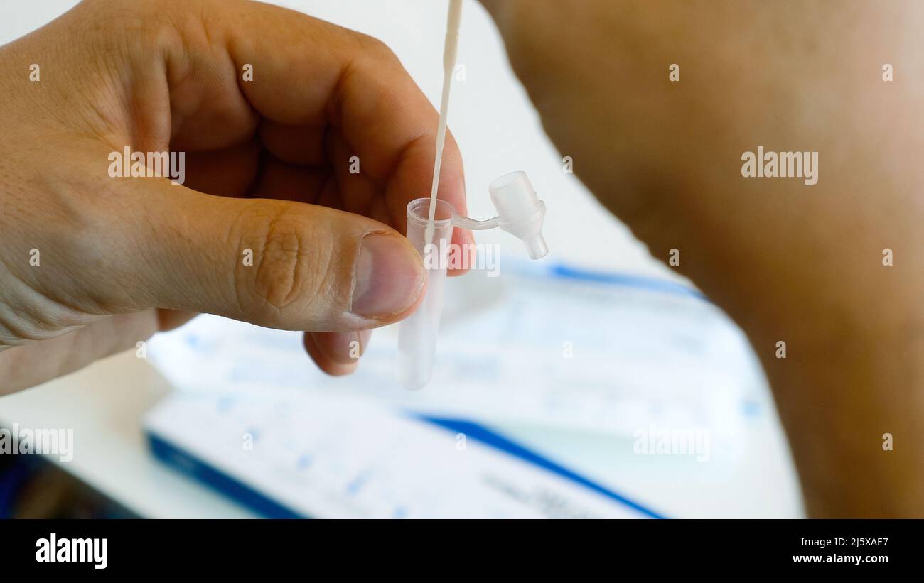 Man hands making self testing on coronavirus and stirring swab in ...