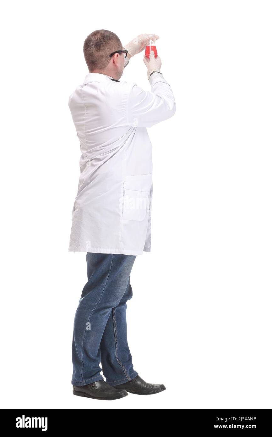 Back view of chemist holding up beaker of red chemical in the ...