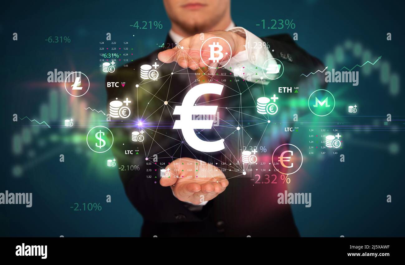 Businessman holding currency symbols concept Stock Photo - Alamy
