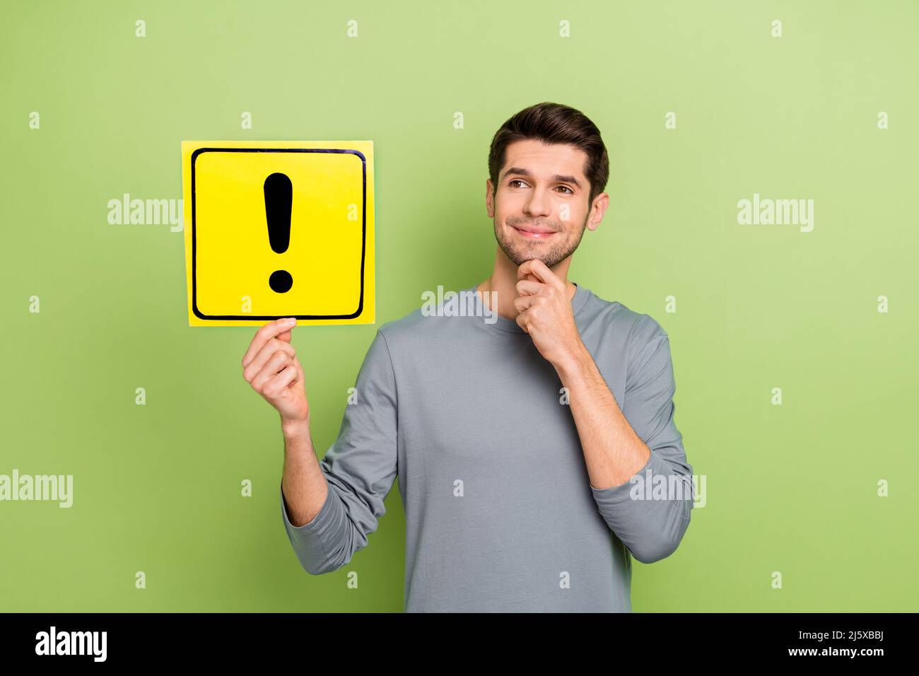 Photo of nice millennial brunet guy hold sign think wear trend cloth ...