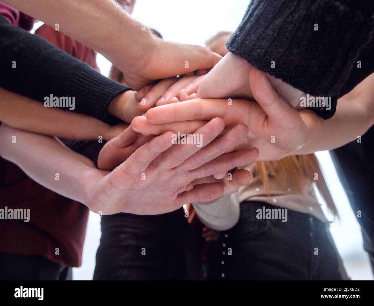 group of diverse young people making a tower out of their hands Stock ...