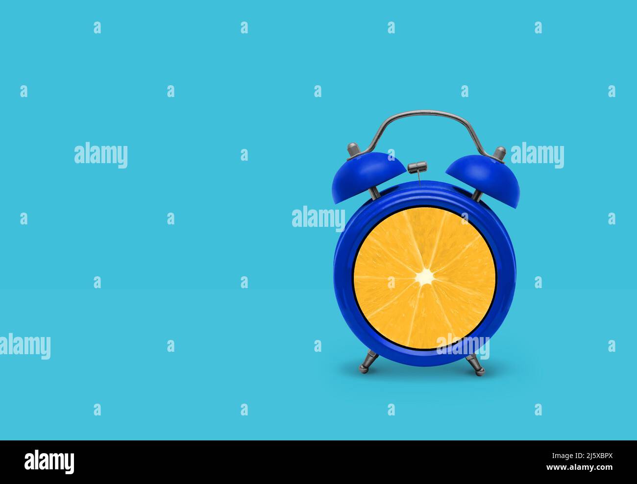 Blue classic metal timer with citrus clock face on cyan background ...