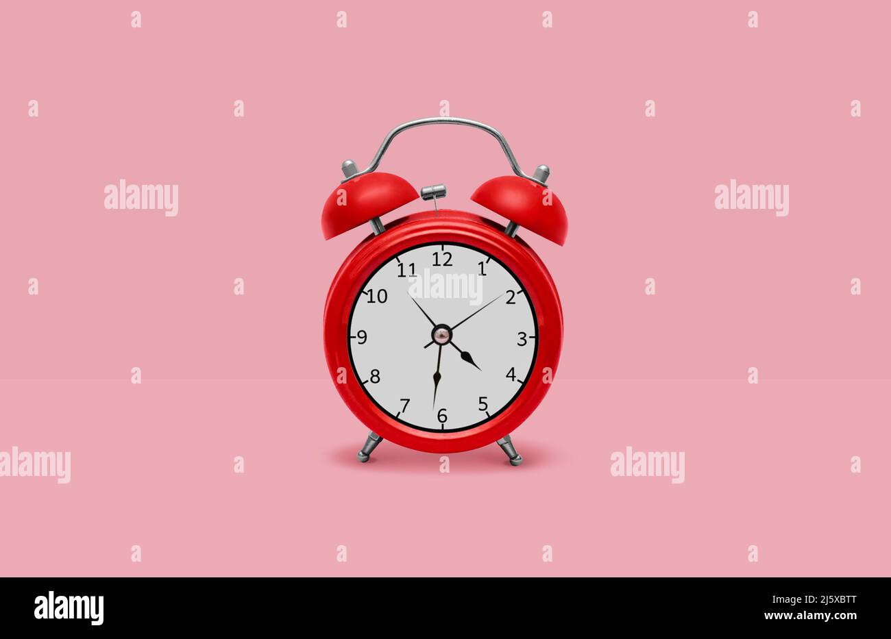 Red classic metal timer on pink background Stock Photo - Alamy