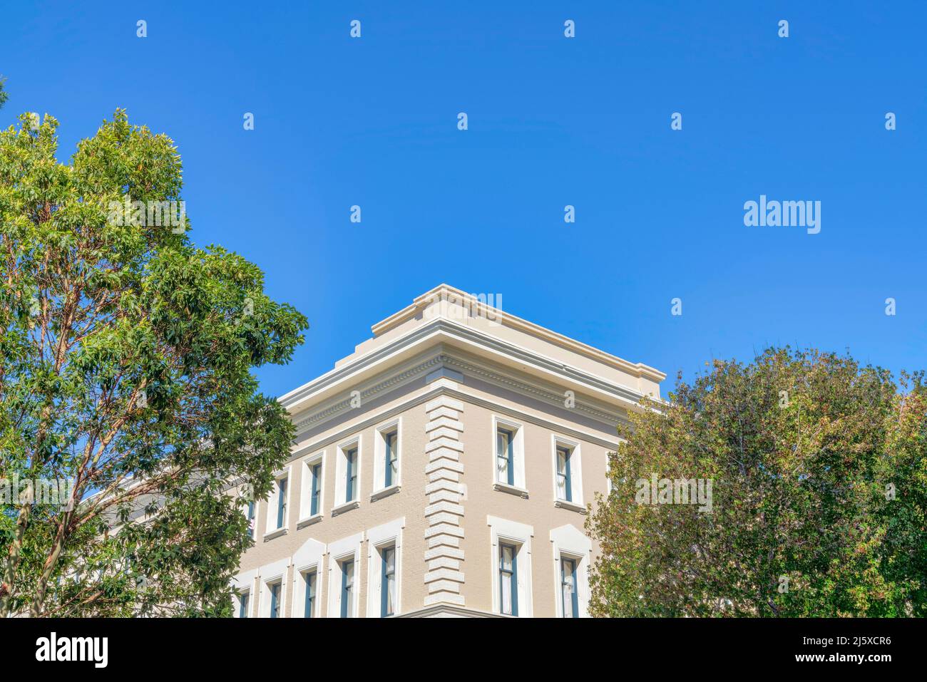 Corner part of a beige building against the clear sky background in San ...