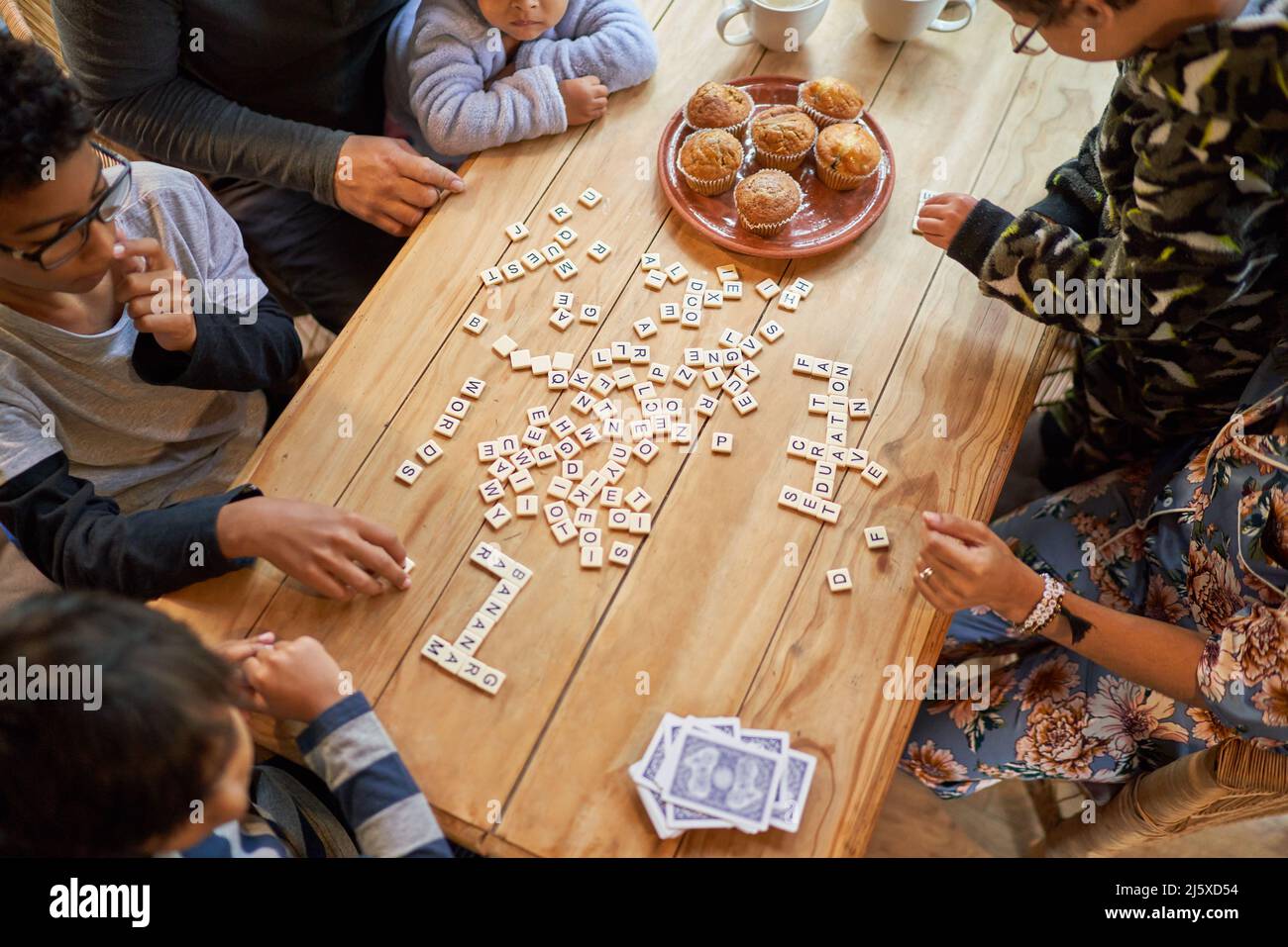Family playing scrabble at dining table Stock Photo - Alamy