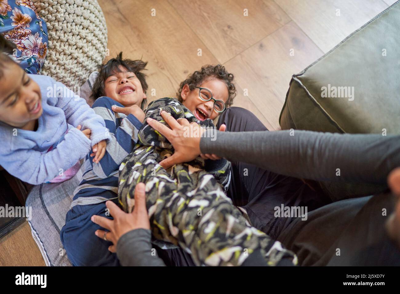 Children tickling boy hi-res stock photography and images - Alamy