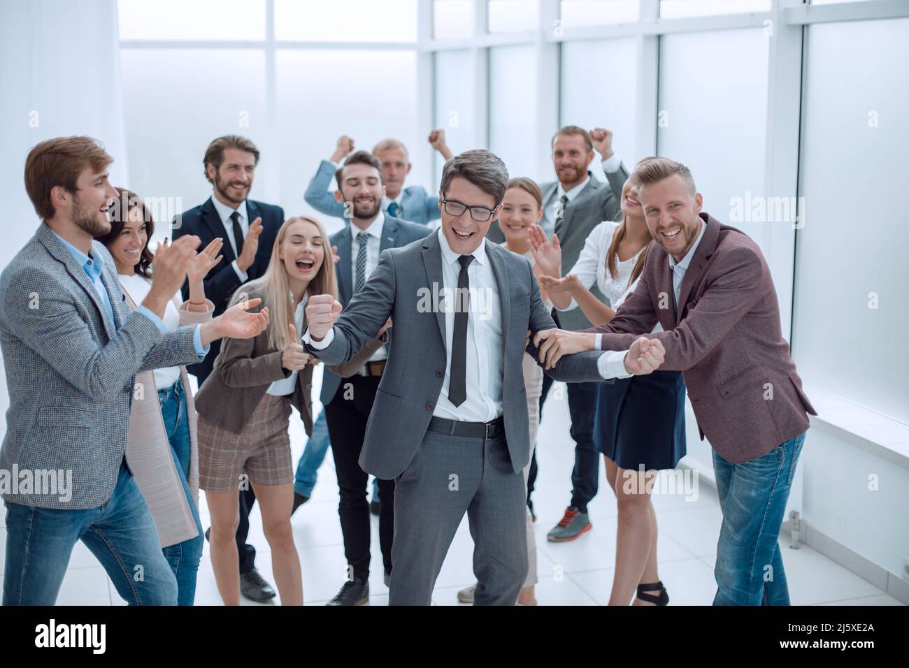 triumphant business team congratulating their leader. success concept ...