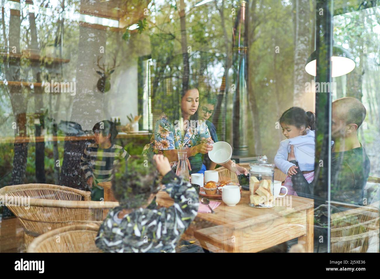 Family eating at dining table in cabin Stock Photo - Alamy