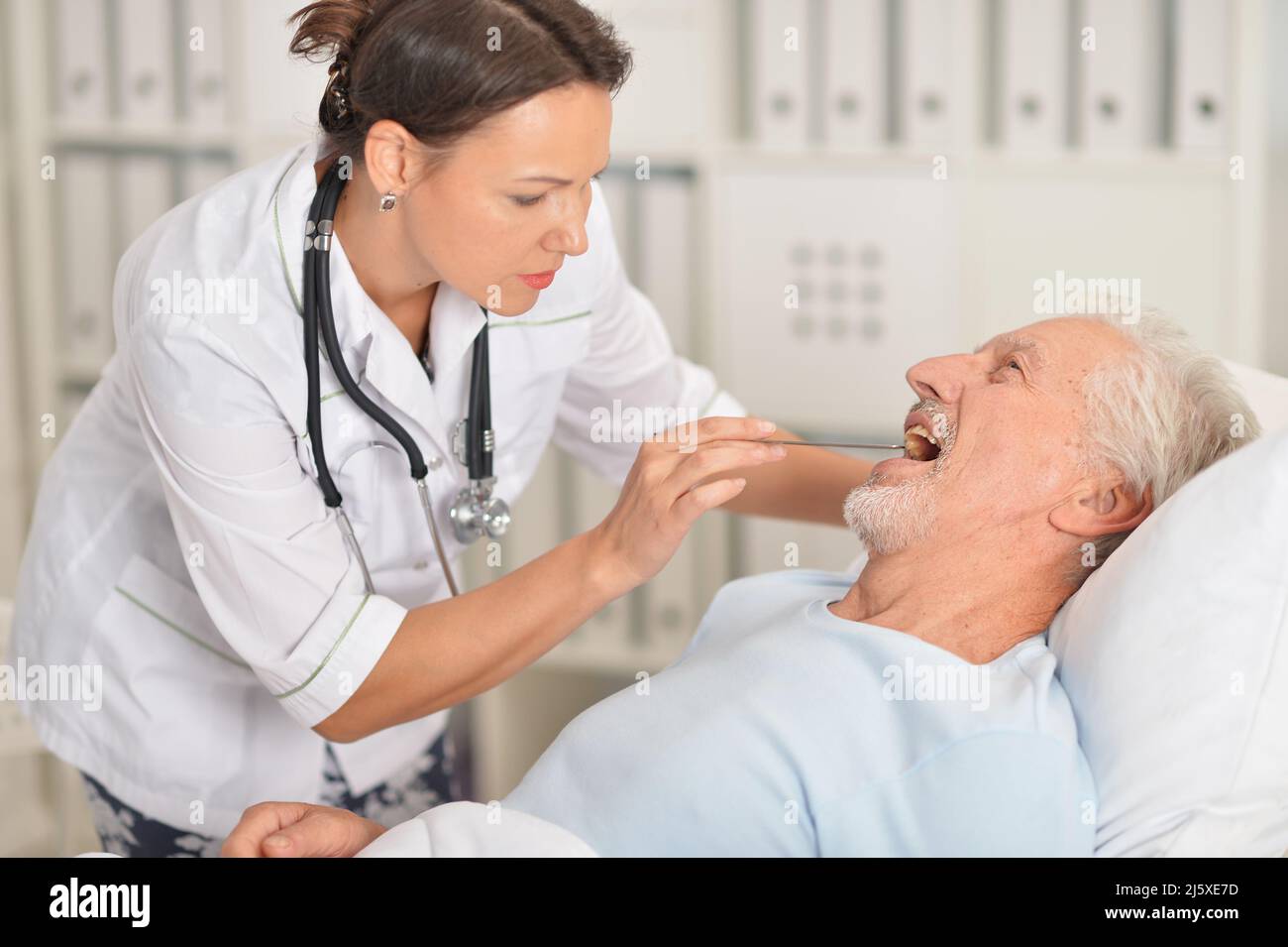 Senior man in hospital with caring doctor Stock Photo - Alamy