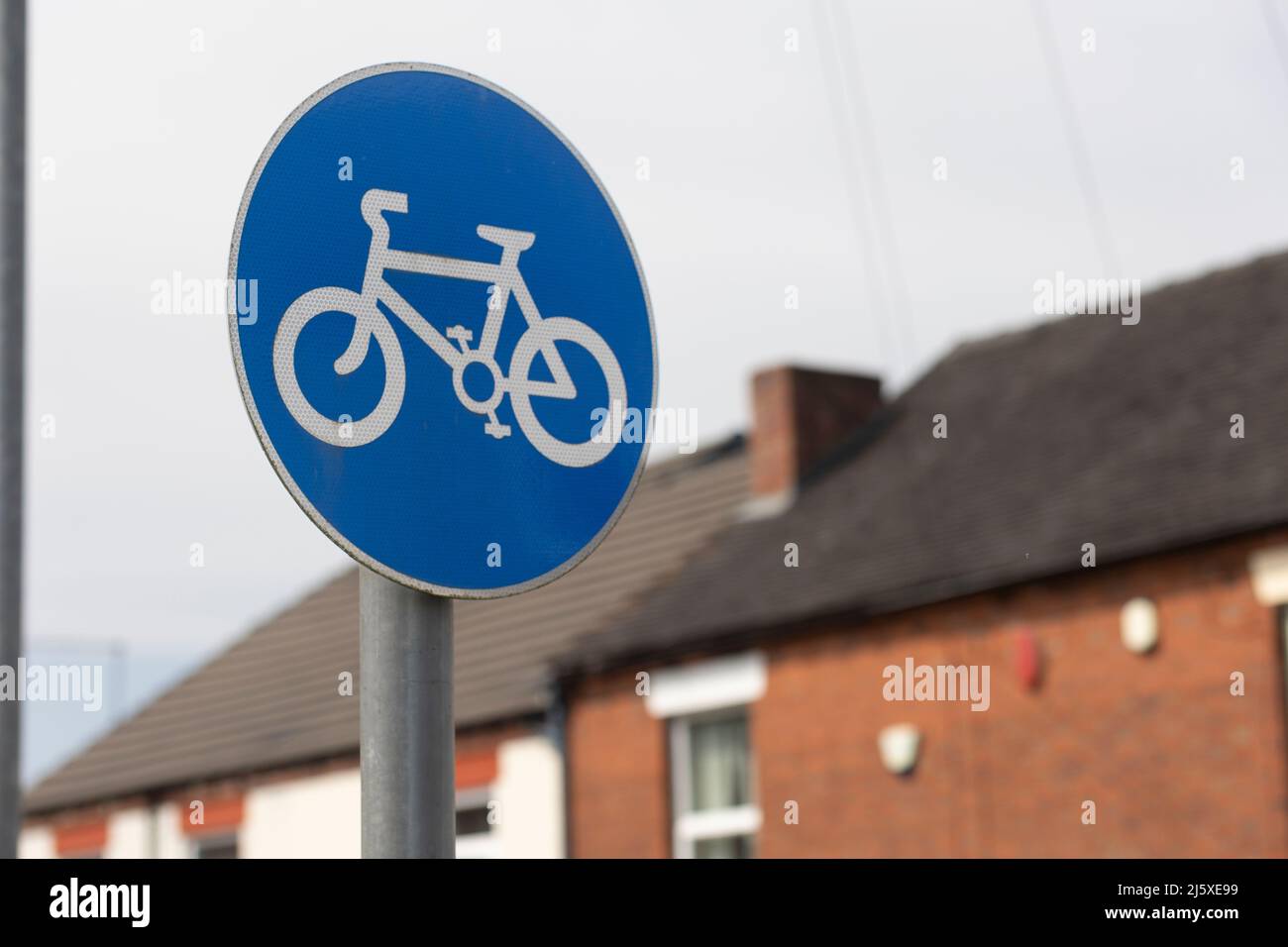 blue cycling allowed sign on a urban street Stock Photo - Alamy