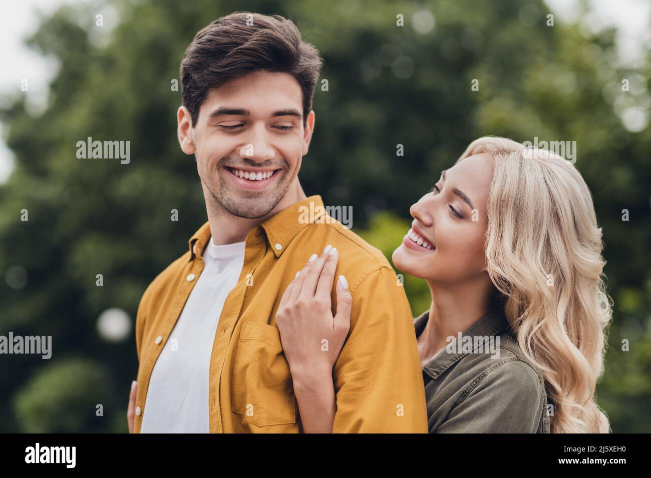 Portrait of attractive tender gentle cheerful amorous couple cuddling ...