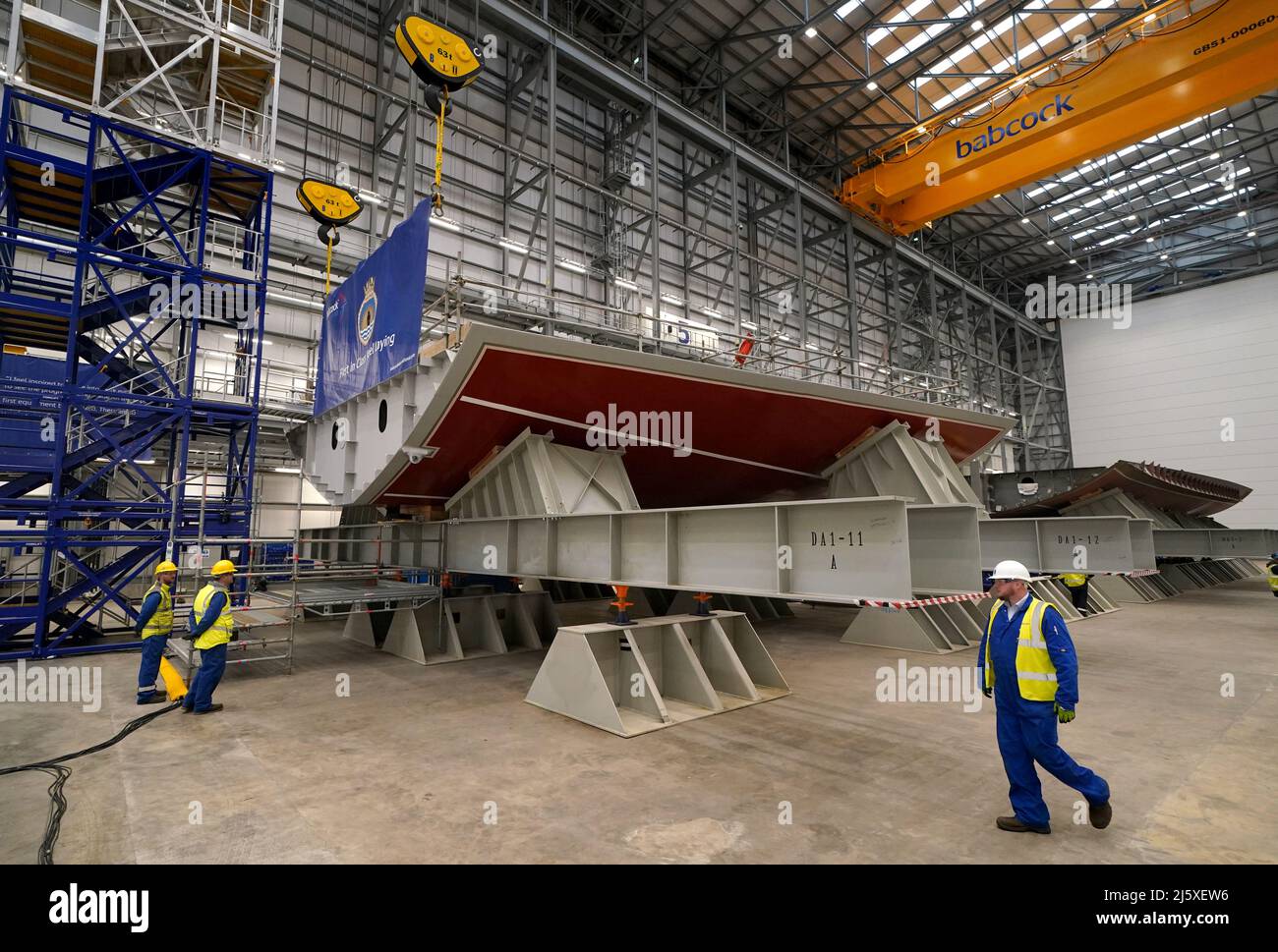A worker passes the Keel before during the Keel Laying Ceremony for the ...