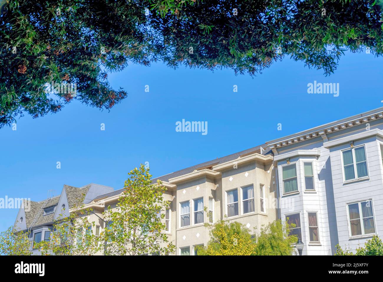 View of townhouse buildings against the clear blue sky at San Francisco ...
