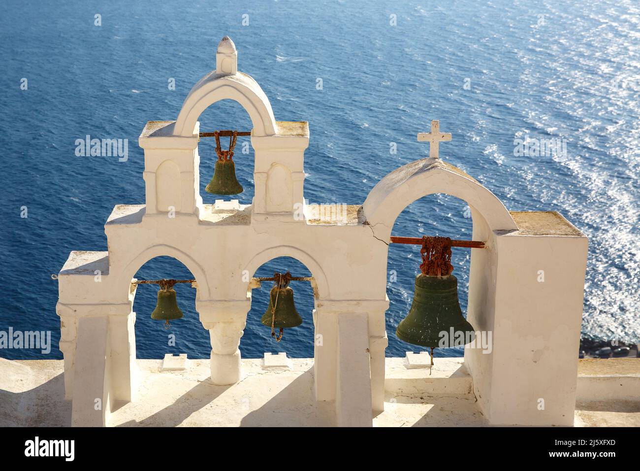 View on calm sea surface through traditional Greek white church arch ...