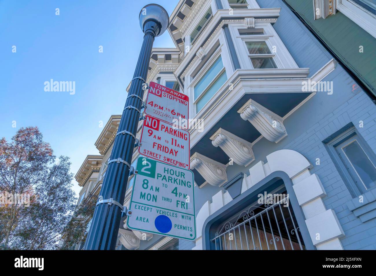 Street parking signs stacked on a street lamp post at San Francisco ...