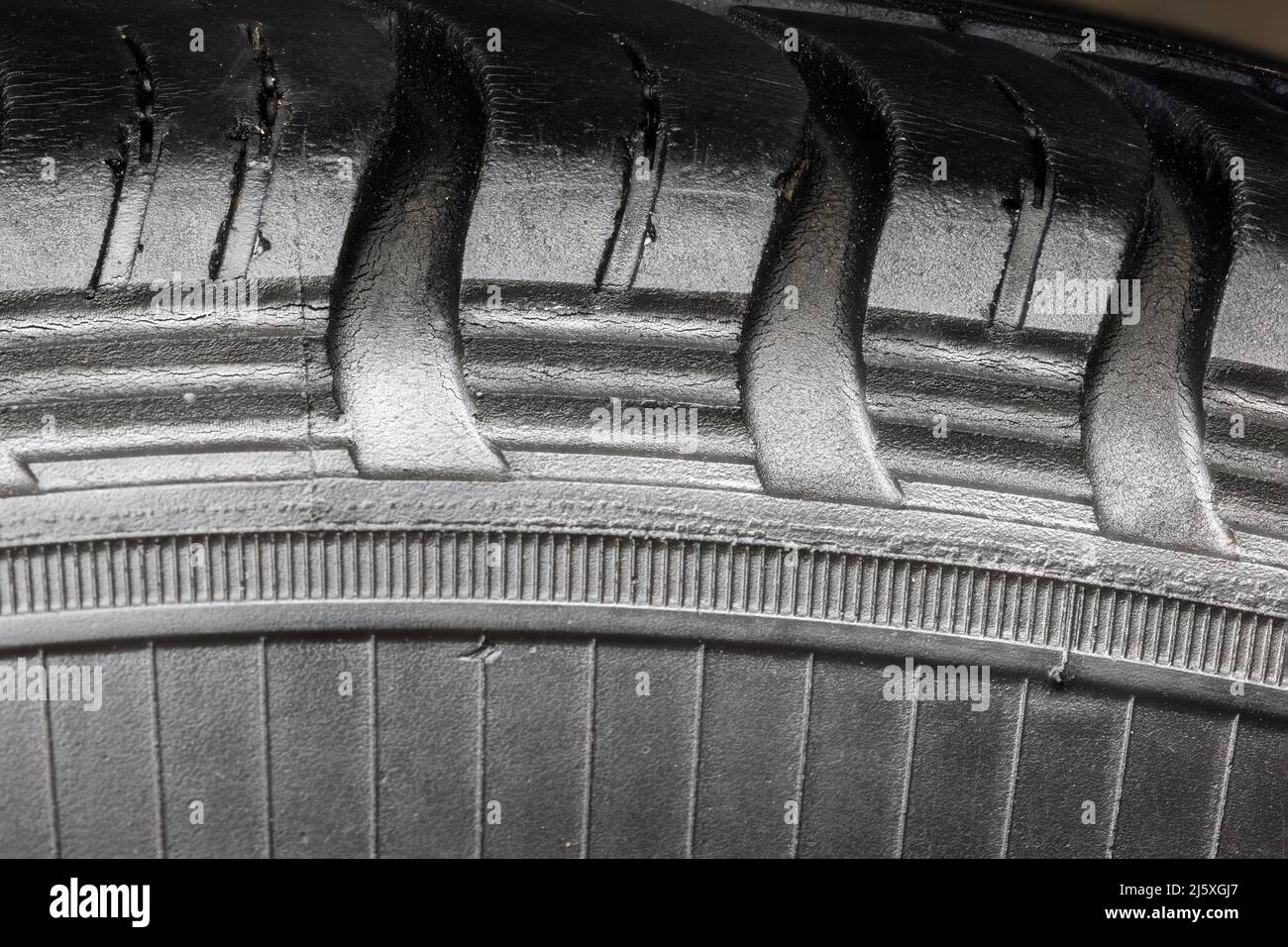 Old worn black tire with many large cracks in the car wheel Stock Photo ...