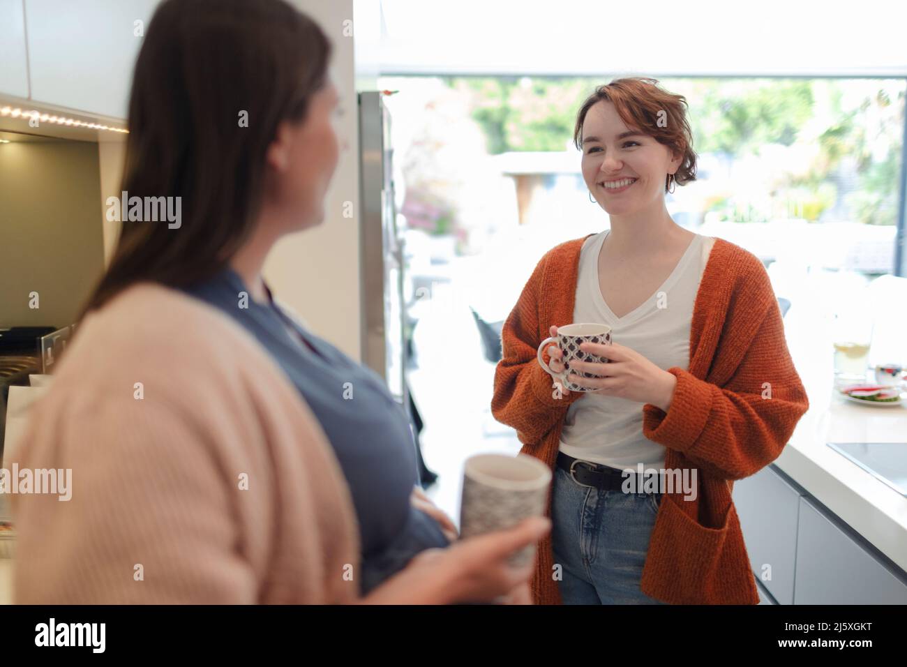Two woman talking in kitchen hi-res stock photography and images - Alamy