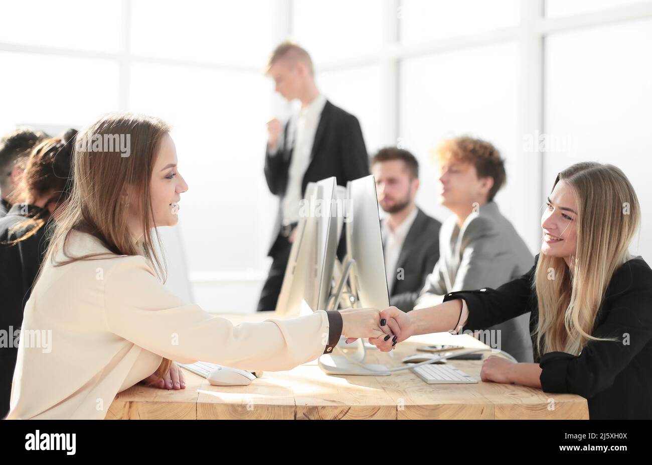 young employees shaking hands at a successful presentation Stock Photo ...