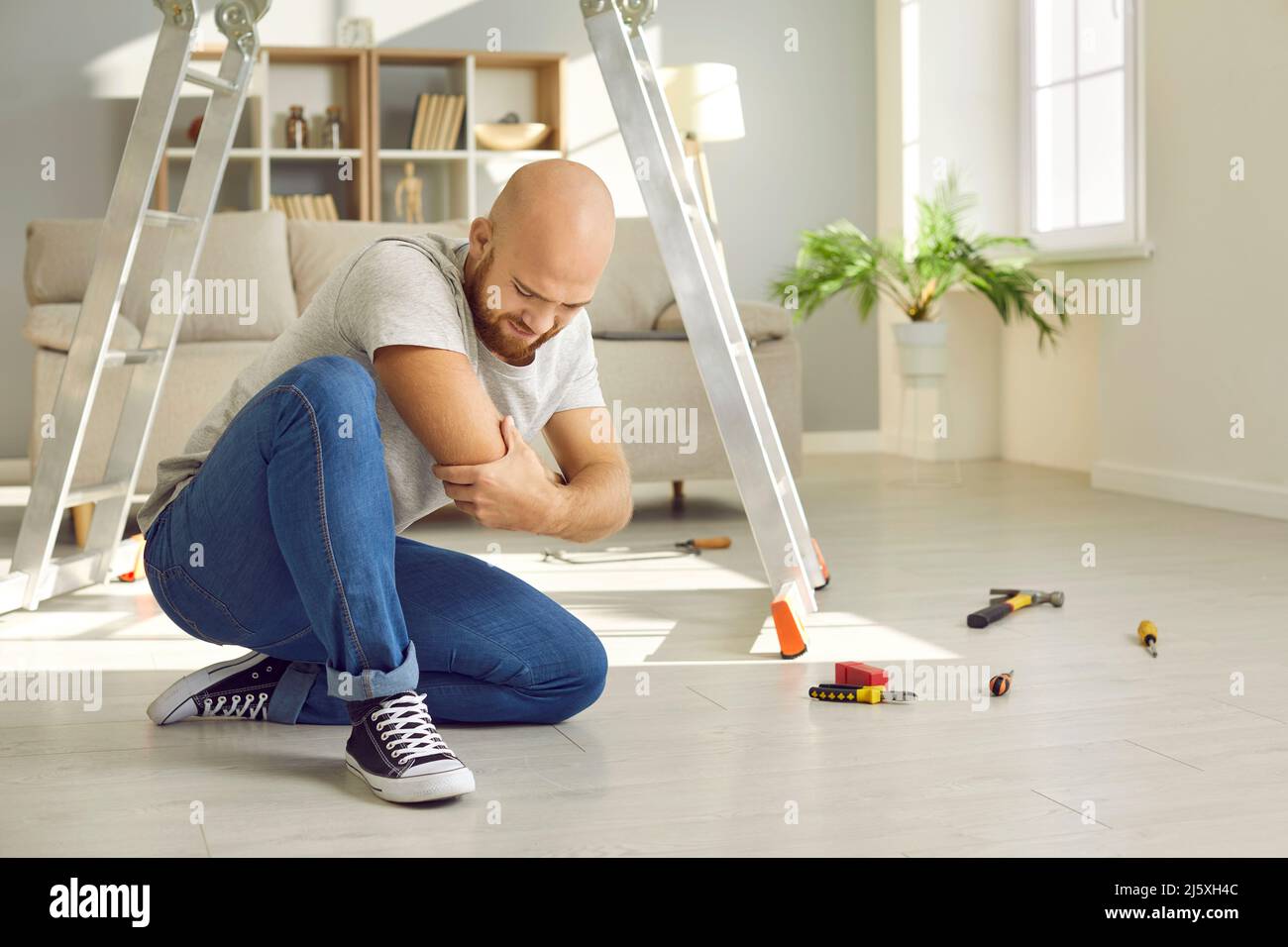 Man fall from ladder injure hand Stock Photo - Alamy