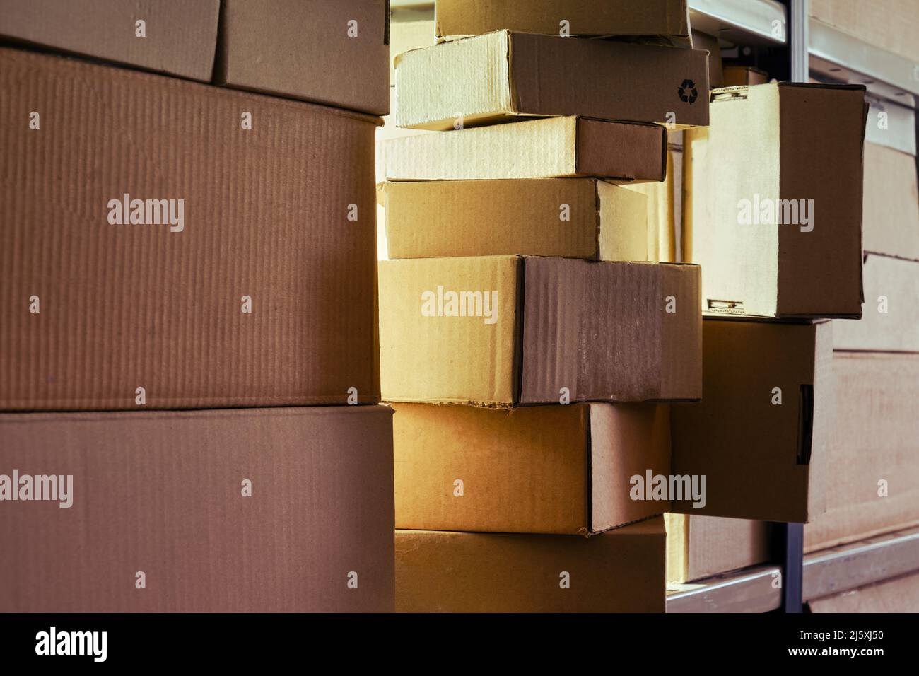 Warehouse overflowing with boxes of goods and postal parcels. Cardboard ...