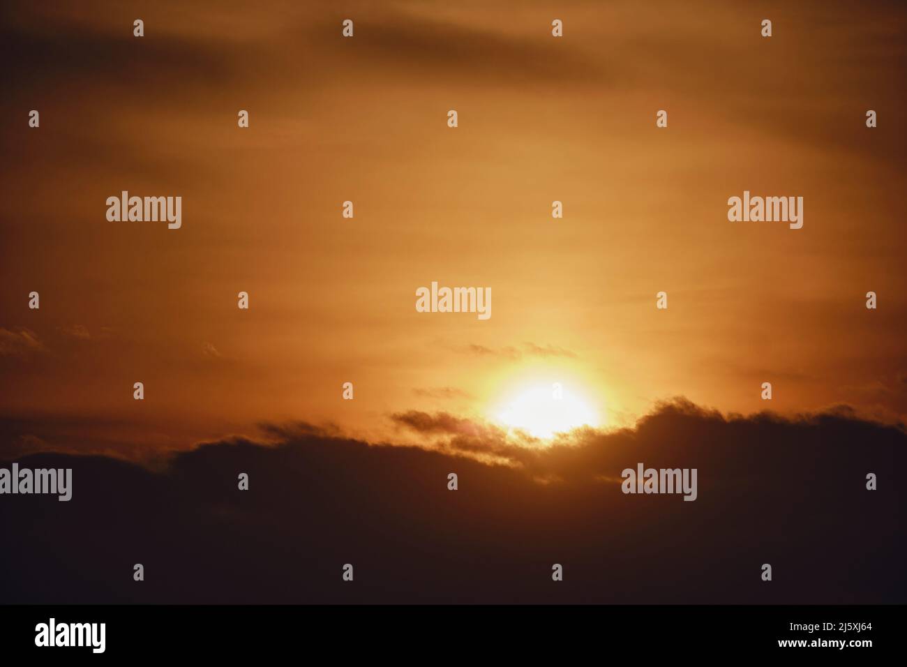 Evening dramatic sky with clouds during sunset. The sun sets behind dark clouds Stock Photo - Alamy