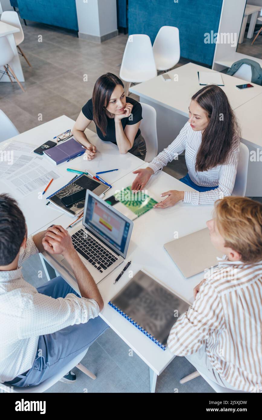 People sitting around table, colleagues working at office Stock Photo ...