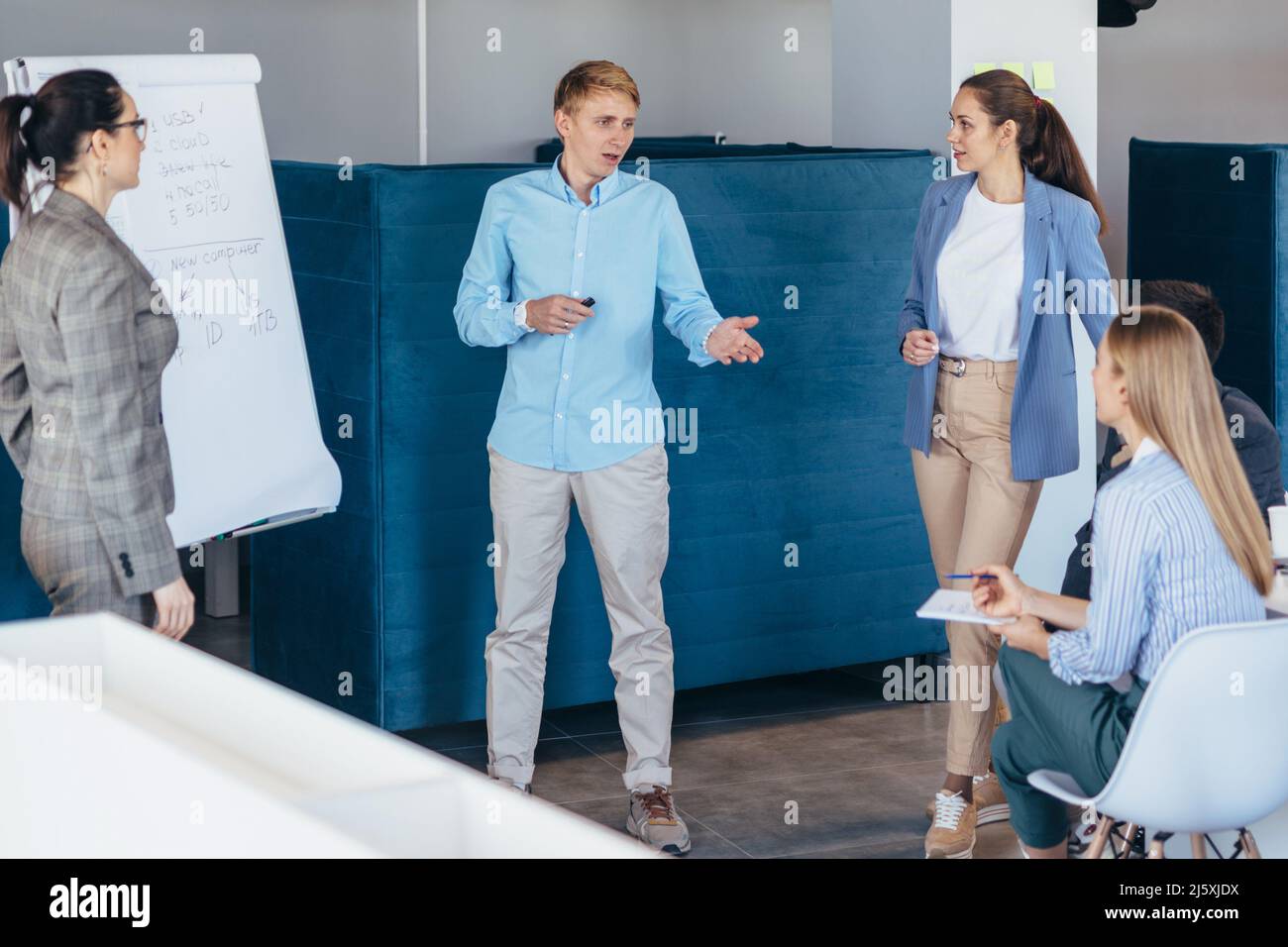 Group of young employees gathered to discuss work issues Stock Photo ...