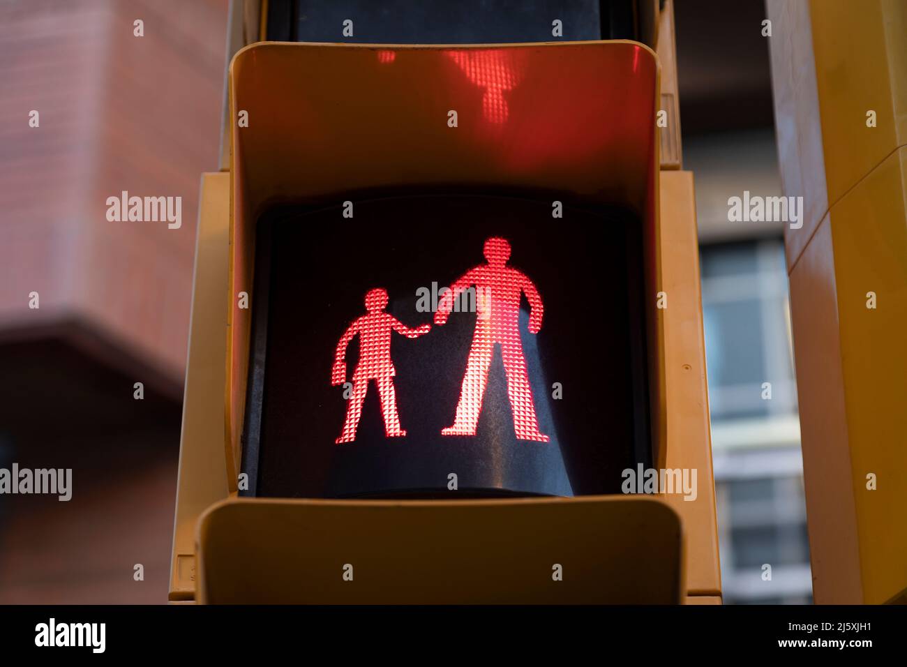 A red traffic light, indicating stop, caution, at a crosswalk in a ...