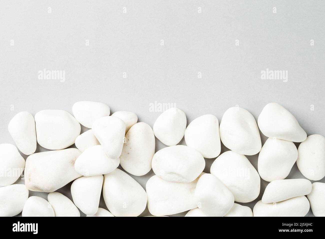 White stone on the grey background. Rock border Stock Photo - Alamy