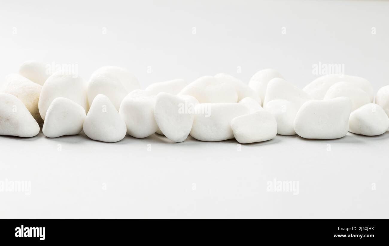 Wide banner with White rocks in a row on the grey background. Stone ...