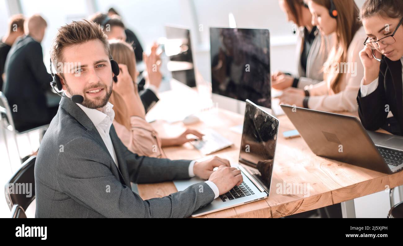 young customer service representative sitting behind a Desk Stock Photo ...