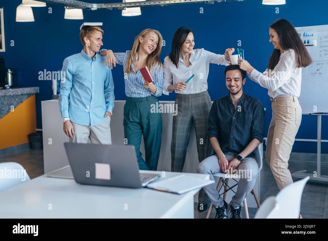 Group of young people in class talking and joking Stock Photo - Alamy