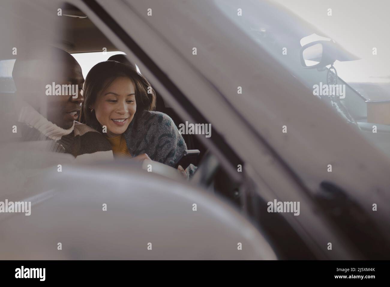 Couple using smart phone in car Stock Photo - Alamy