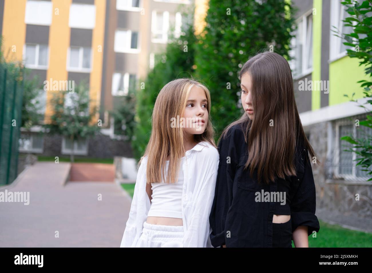 Fraternal Twins Sisters Blonde And Brunette Teen Girls In Fashionable