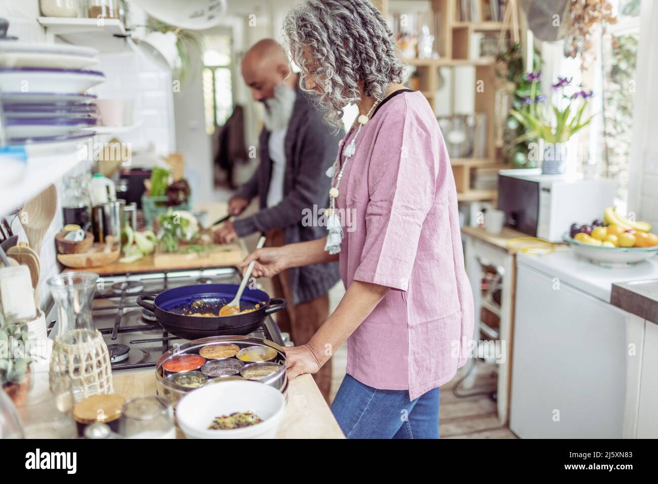Woman cooking at stove hi-res stock photography and images - Alamy