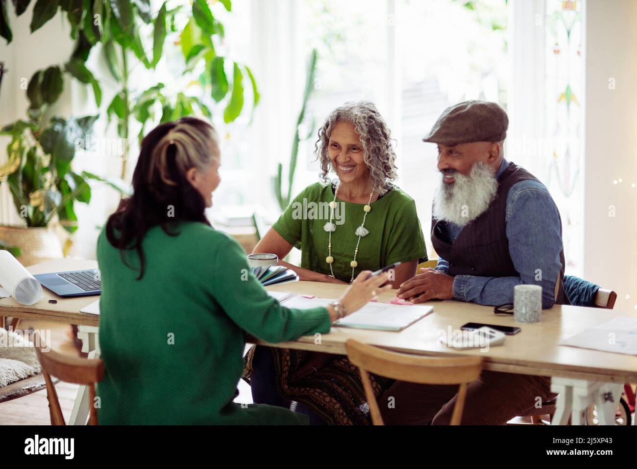 Happy couple meeting with interior designer at home Stock Photo - Alamy
