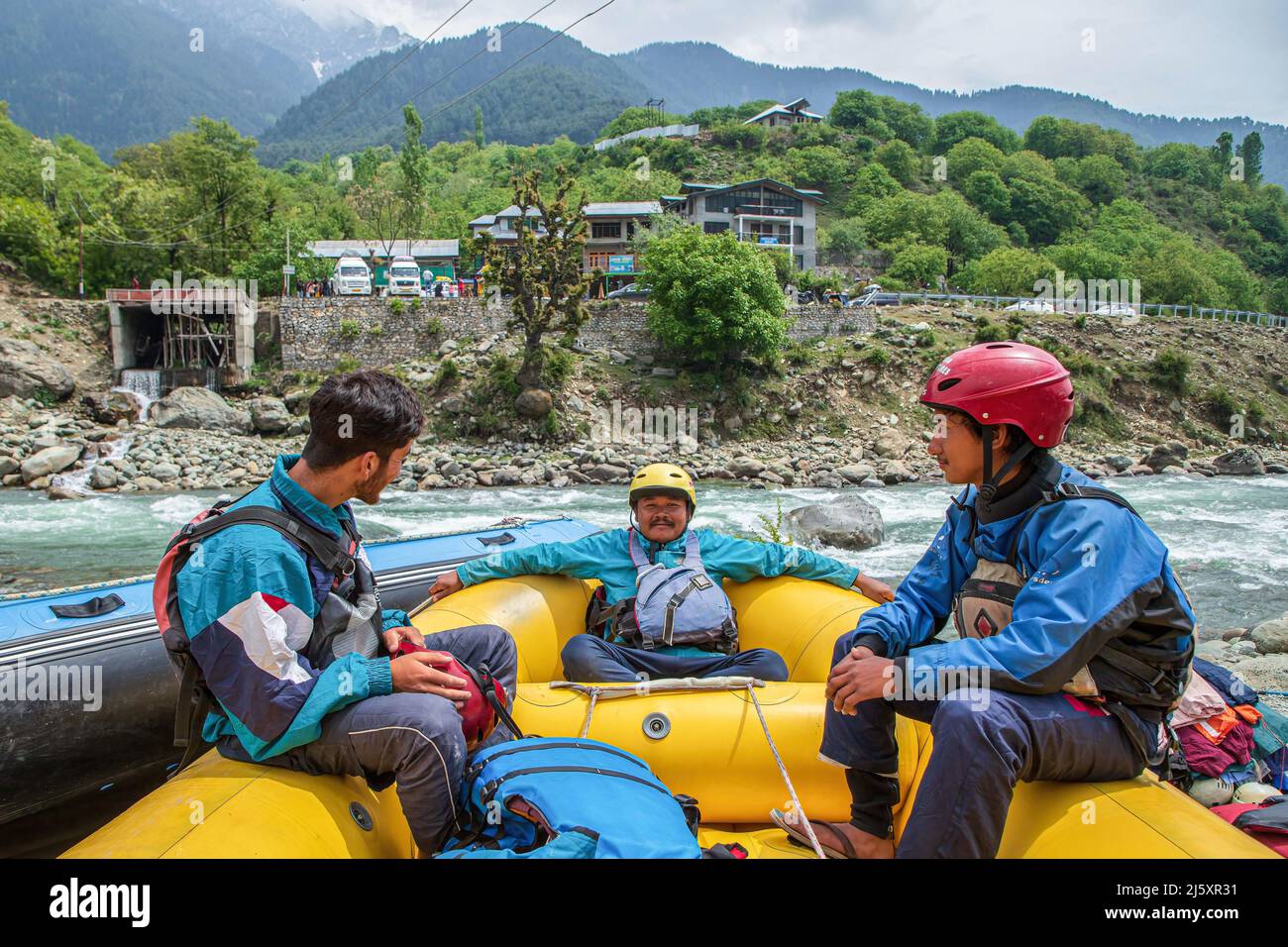 Indian tourists are seen sitting on a boat before rafting in a Lidder ...