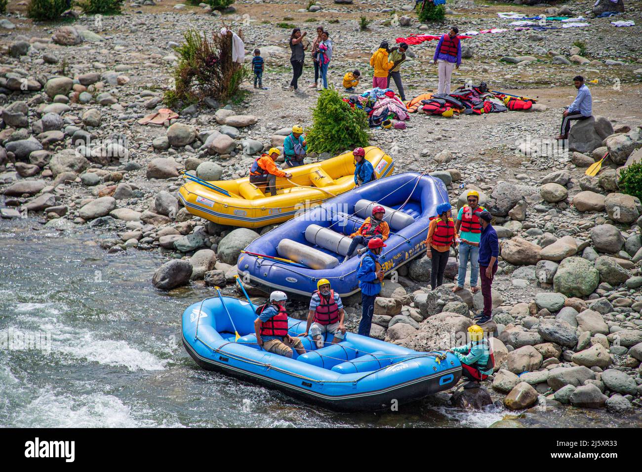 Indian tourists are seen wearing helmets and life jackets sitting on ...