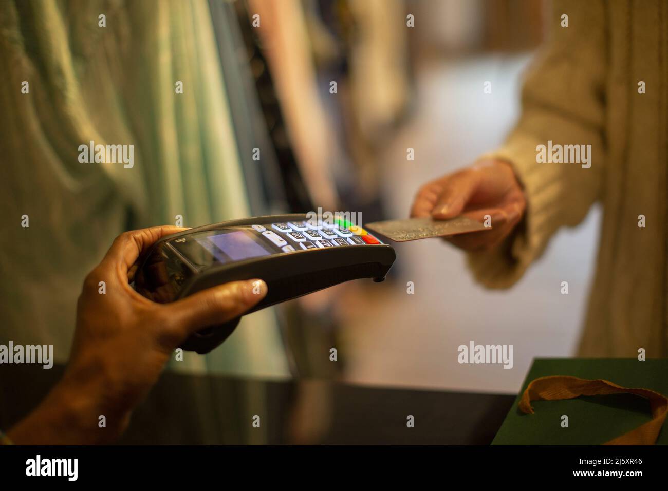 Close up customer with credit card paying at credit card reader Stock ...