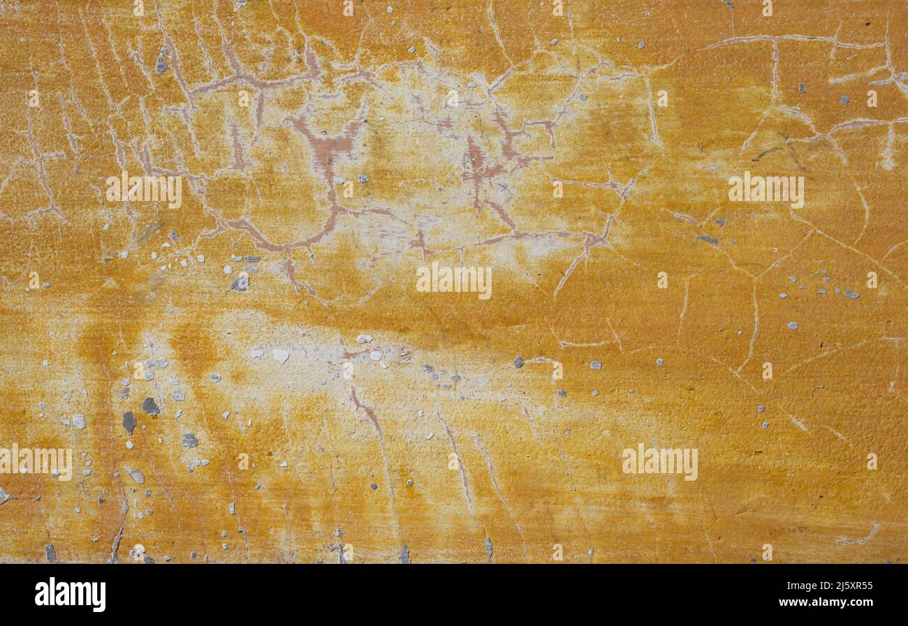 Distressed golden yellow cement wall background texture Stock Photo - Alamy
