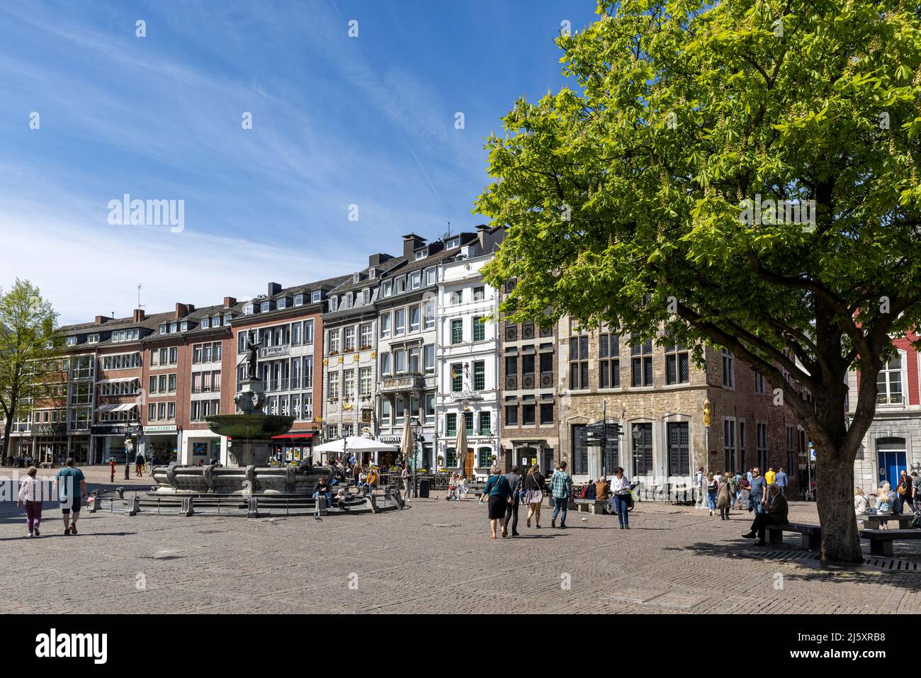People spending warm sunday spring day on Aachen town square in Germany ...