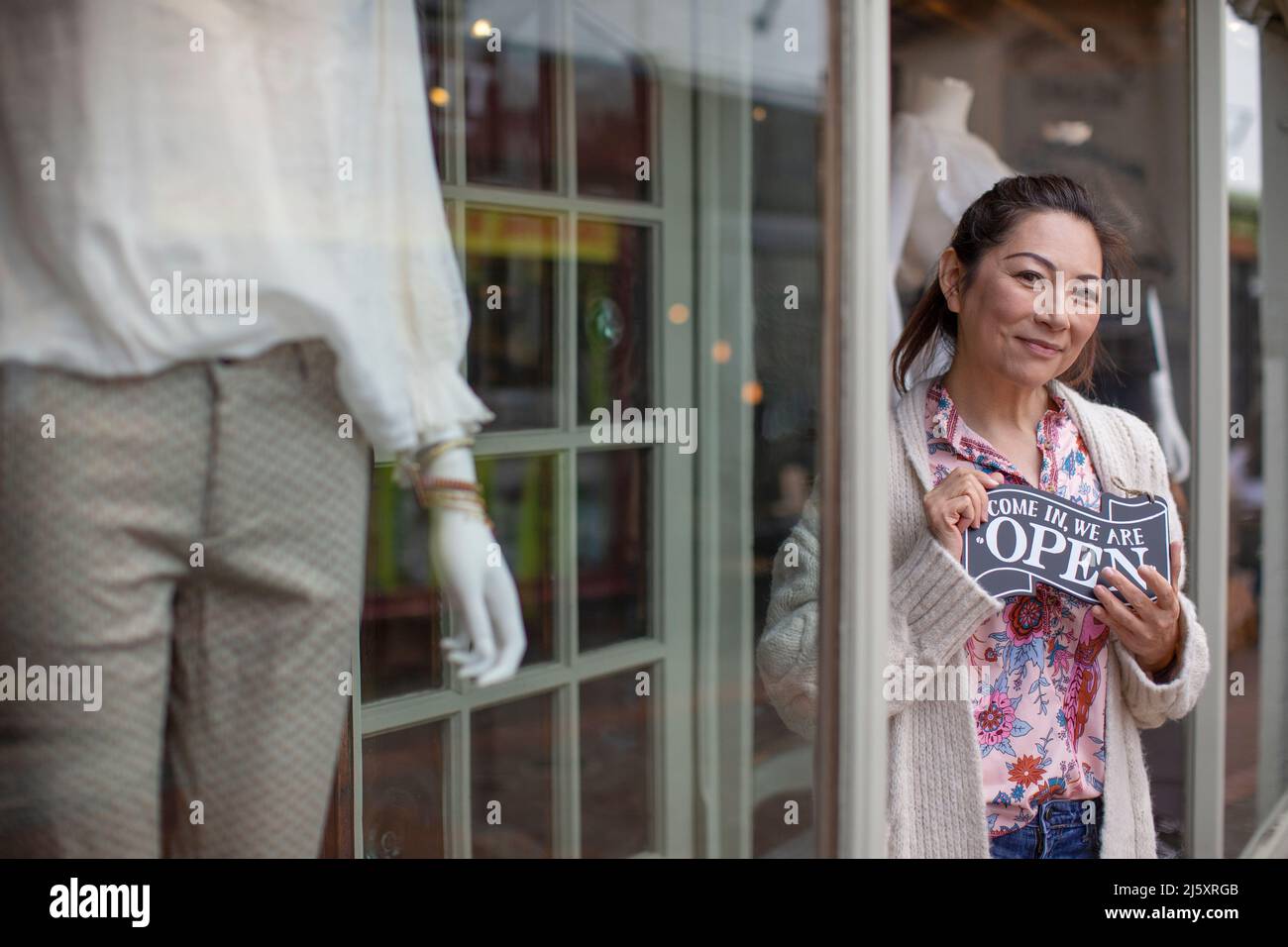 Woman holding happy sign hi-res stock photography and images - Alamy
