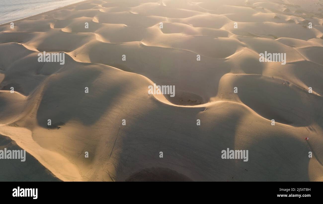 Sand dunes meet the Atlantic Ocean. Top view of Maspalomas sand dunes ...