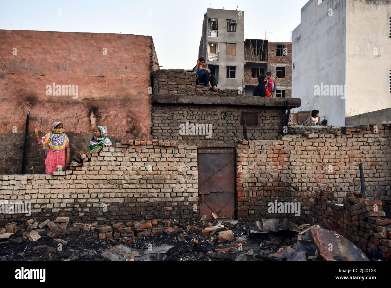 New Delhi, India. April 25, 2022, People seeing their house which got ...