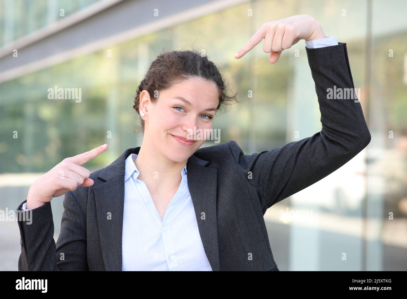 Front view portrait of a proud businesswoman pointing herself in the ...