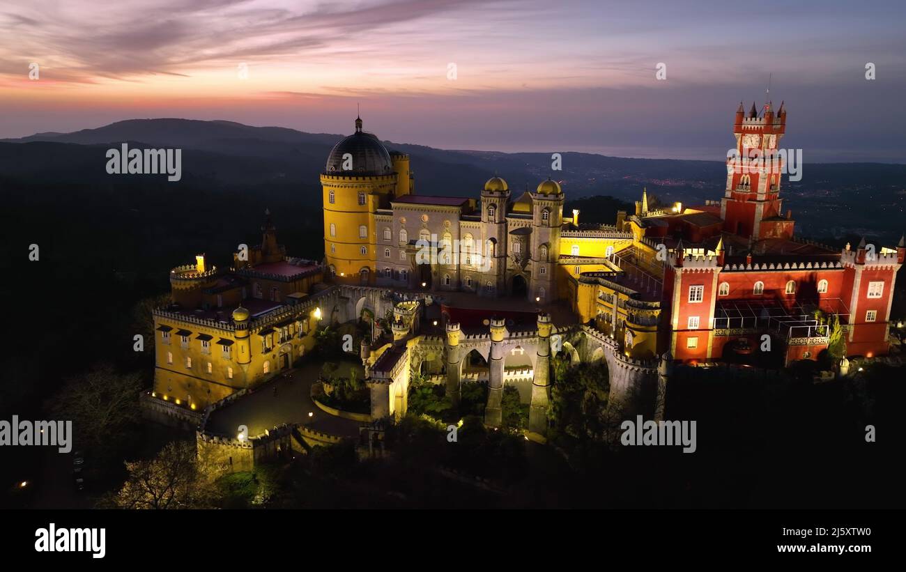 Aerial view of stunning Pena Castle at night. Top view of illuminated ...