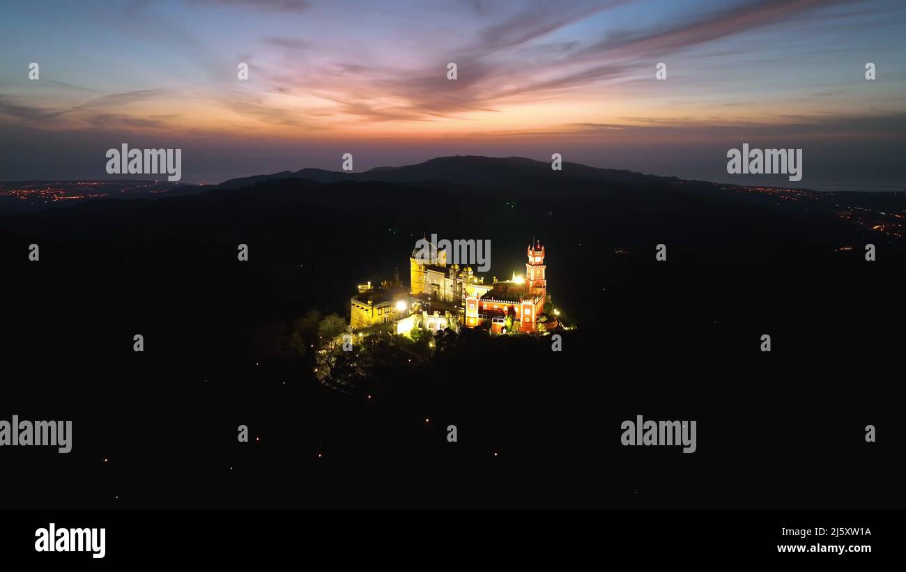 Aerial view of stunning Pena Castle at night. Top view of illuminated ...