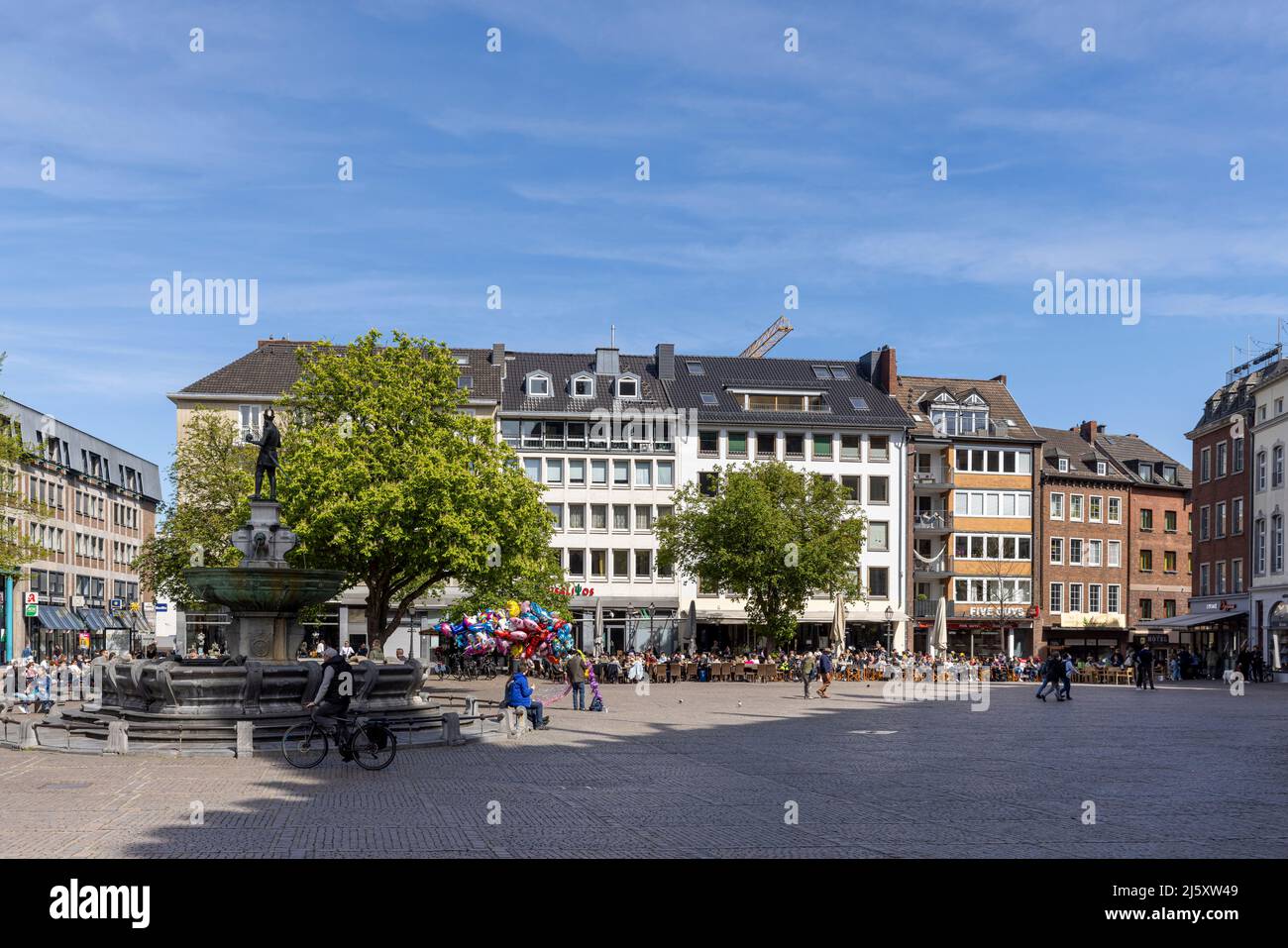 People spending warm sunday spring day on Aachen town square in Germany ...